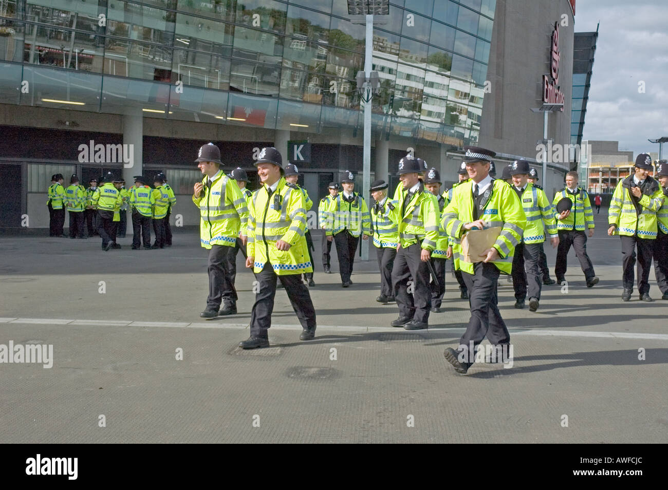 Smiling police officers on the podium of Arsenal's Emirates Stadium ...