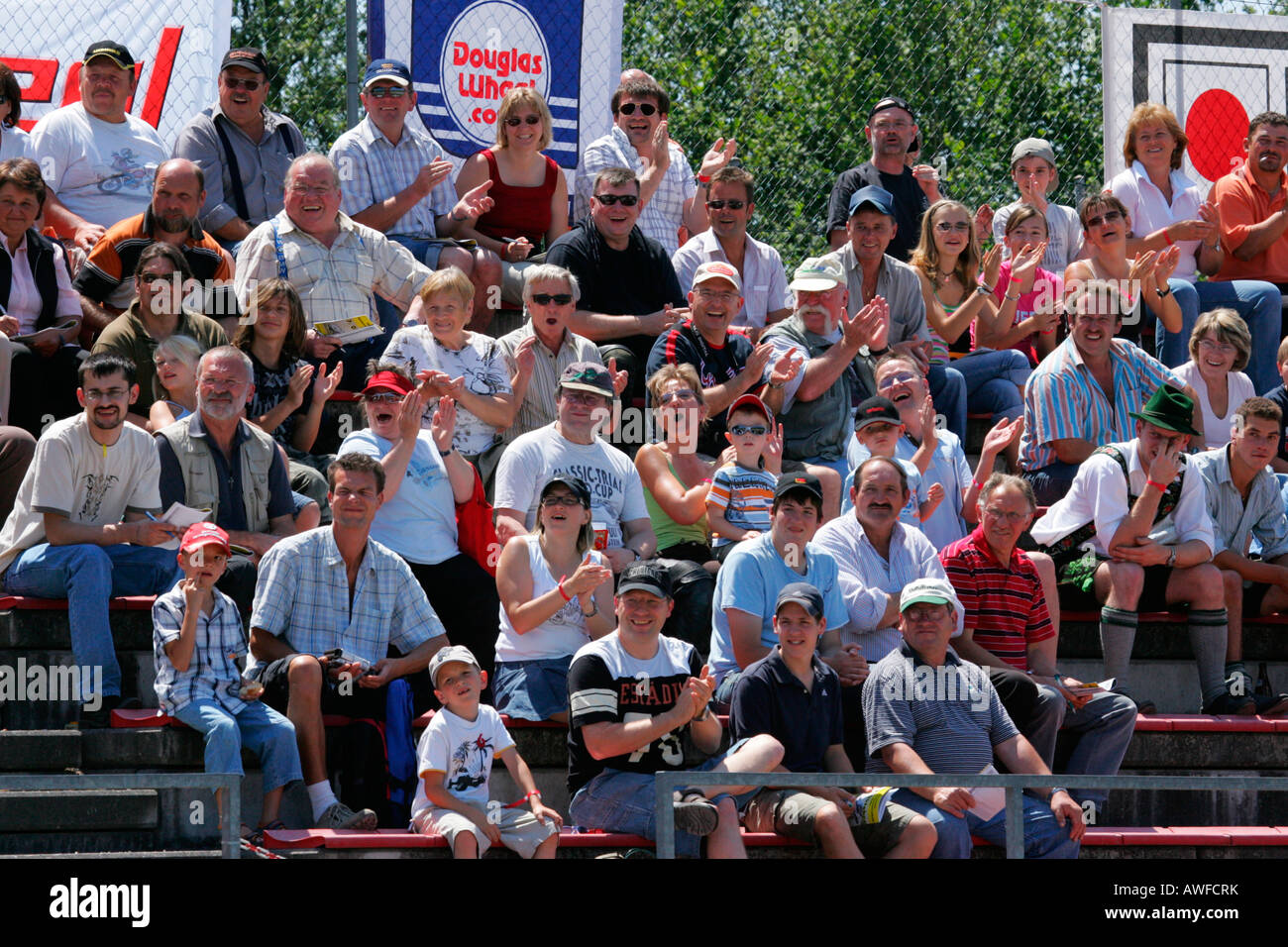 Spectators in the stands at an international motorcycle race on a dirt ...