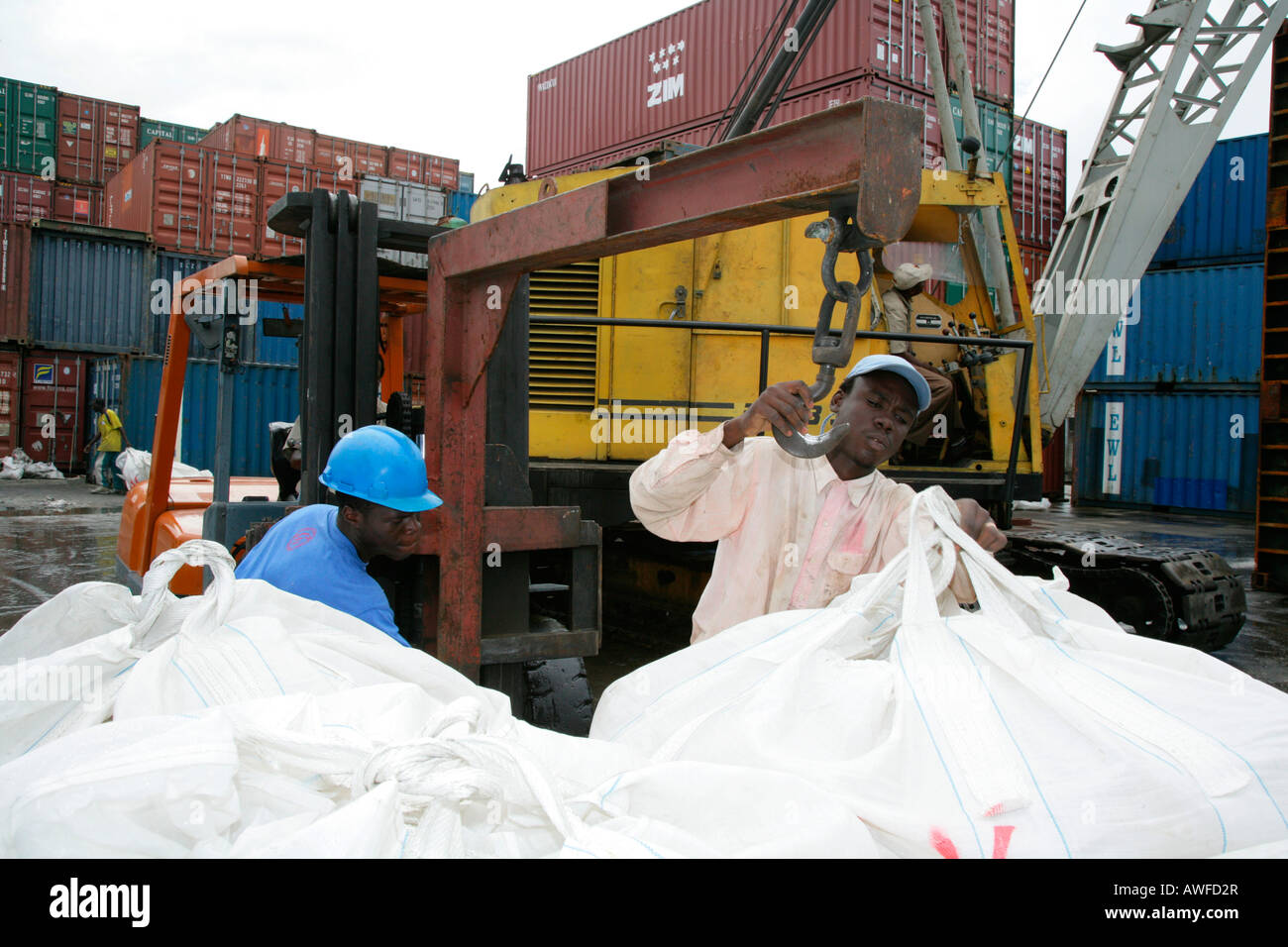 Dock workers loading rice at John Fernandes transshipment port in ...