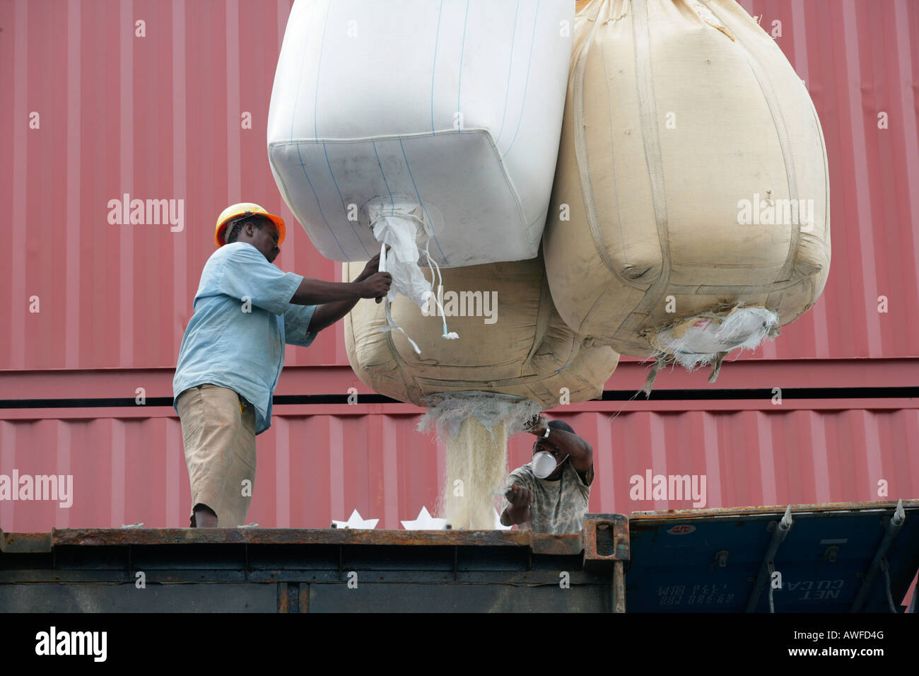 Dock workers loading rice at John Fernandes transshipment port in ...