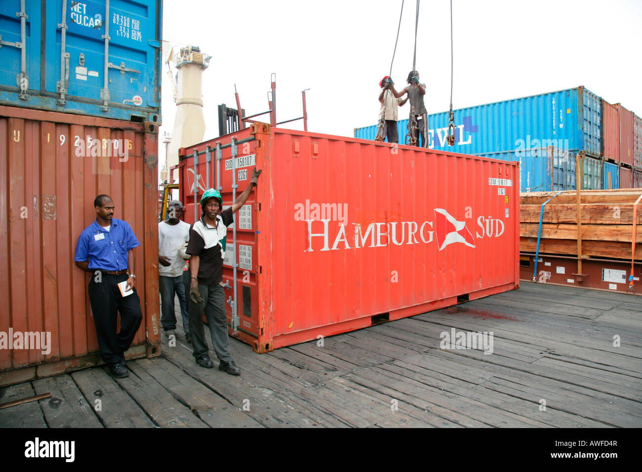 Dock workers loading containers at John Fernandes transshipment port in ...