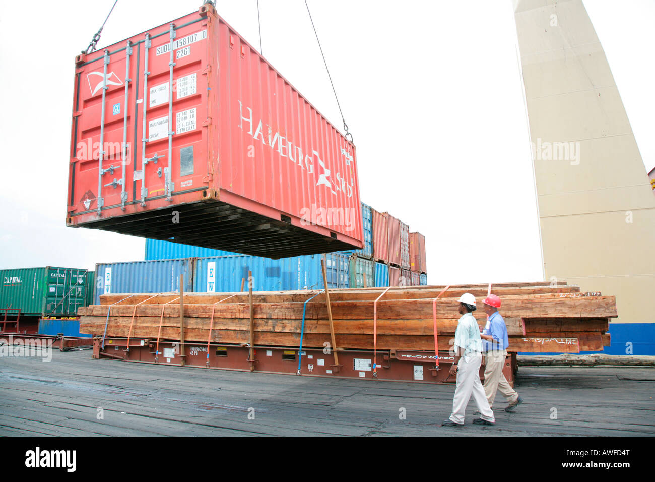 Dock workers loading containers at John Fernandes transshipment port in ...