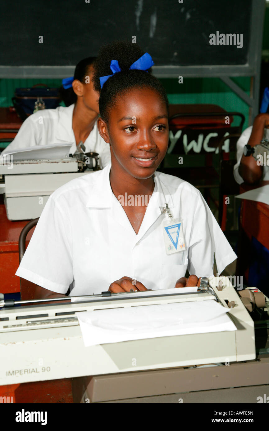 Girls wearing school uniforms in typing class at a training centre for ...