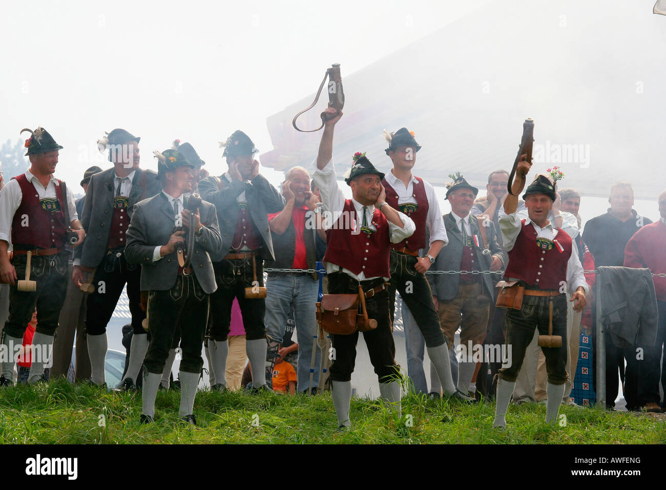 Riflemen firing a gun salute during a folk festival in Muehldorf am Inn ...