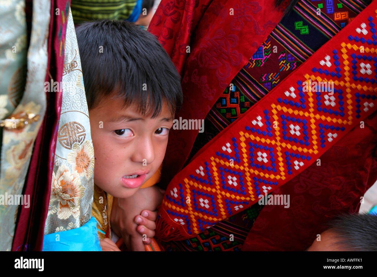 The curios look of a child appear from two women at the Thimphu ...
