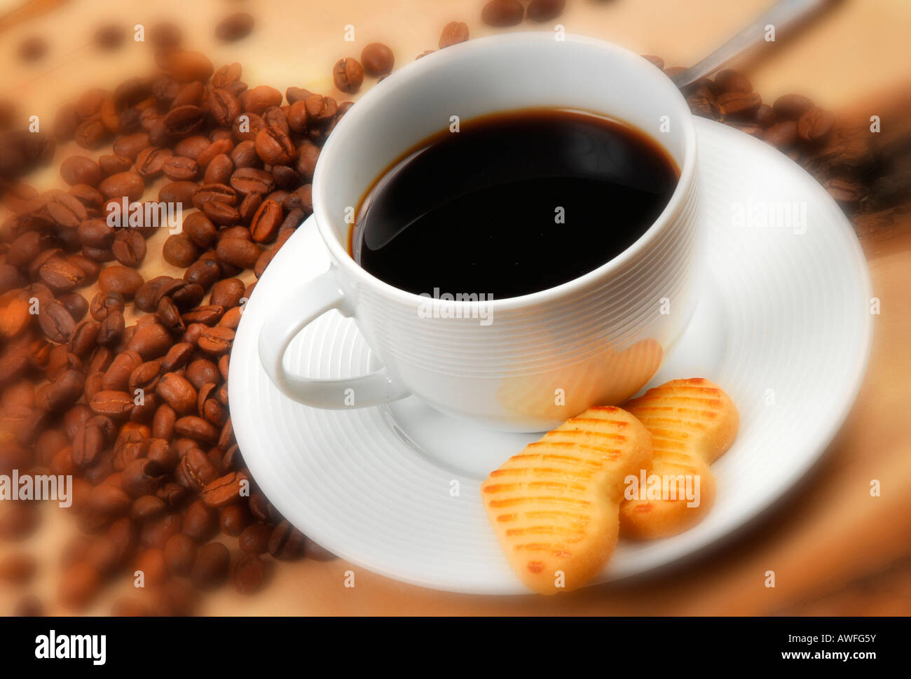 Cup of coffee, coffee beans at the back Stock Photo - Alamy