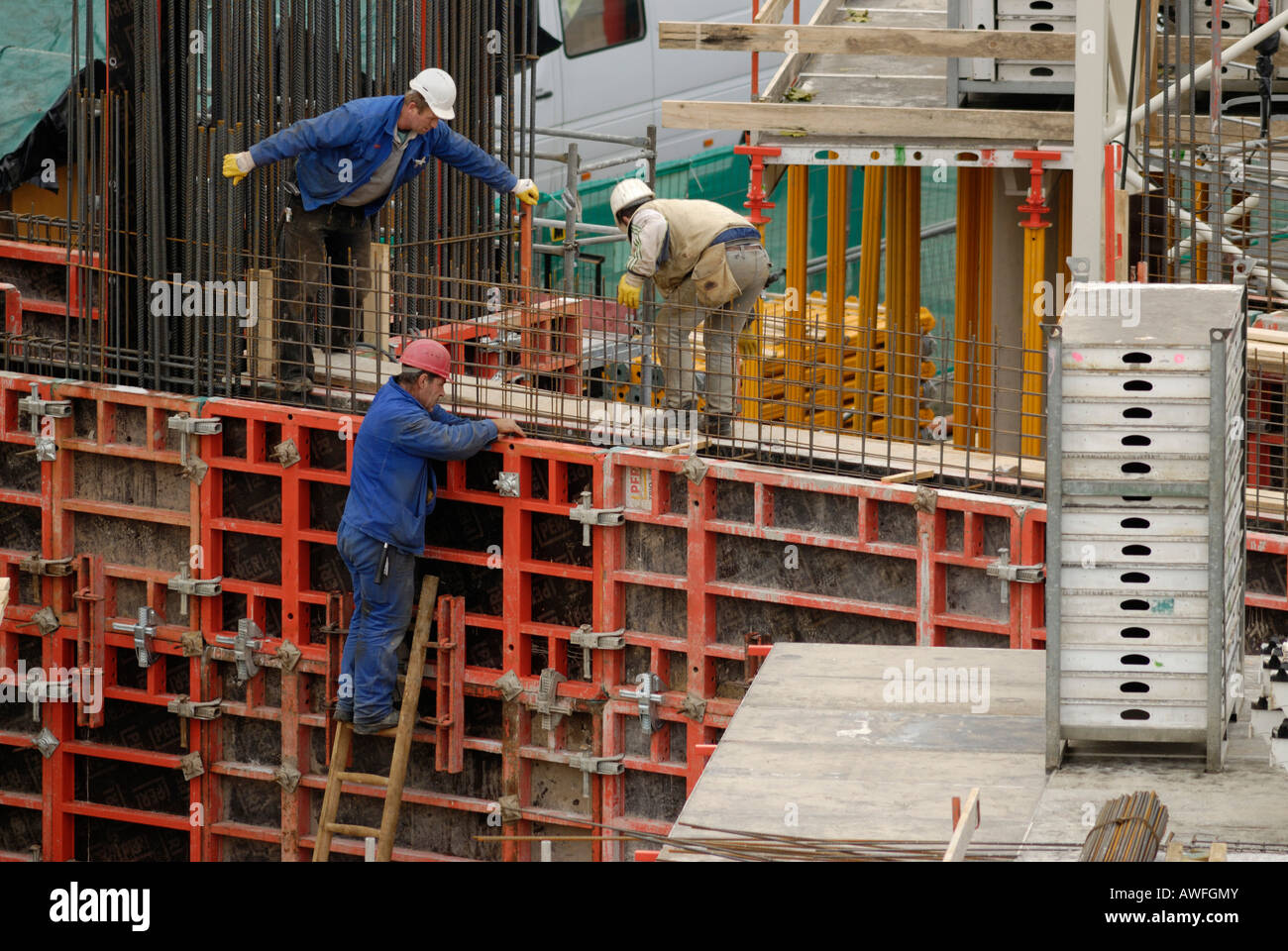 Three construction workers setting up falsework, moulds (formwork Stock Photo - Alamy