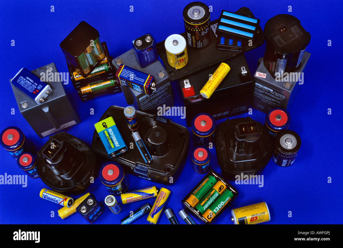 Old rechargeable batteries against a blue backdrop Stock Photo - Alamy