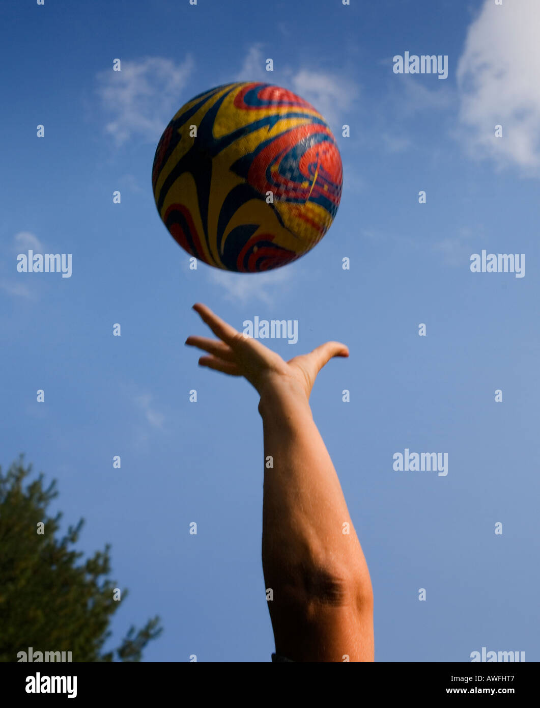 Hand tossing a ball into the air Stock Photo - Alamy