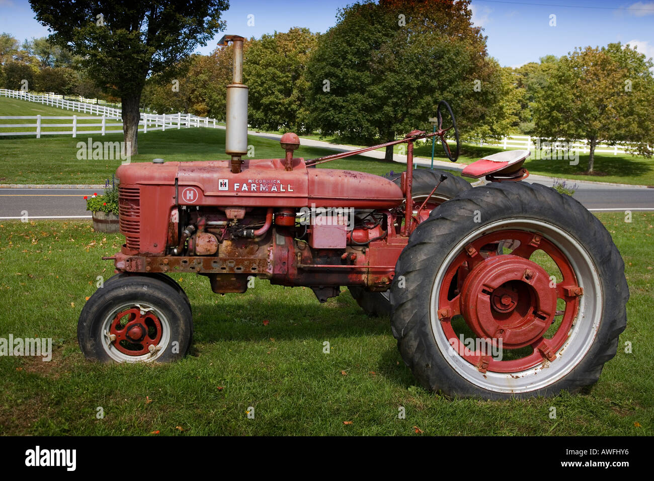 Old farm tractor on the side of a road Stock Photo - Alamy