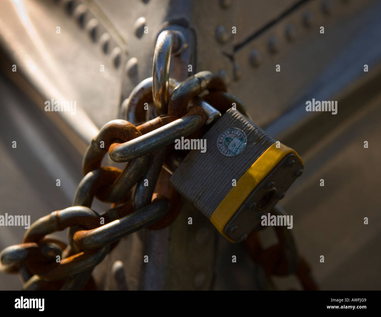 Lock and chain holding a boat to a dock Stock Photo - Alamy