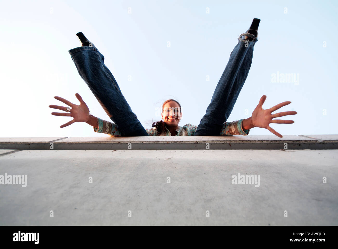 crazy girl on a wall stretching her arms and legs Stock Photo - Alamy