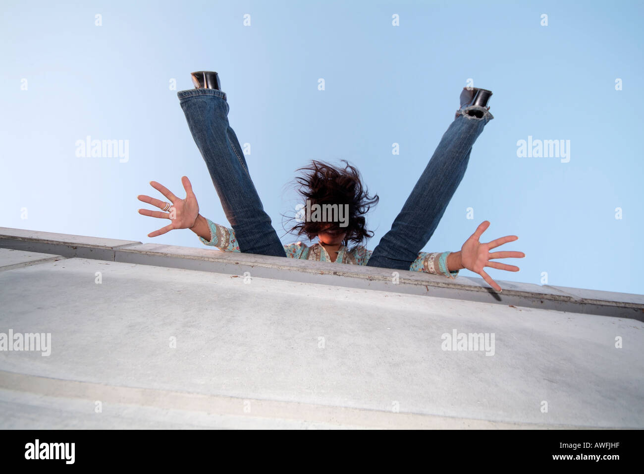 crazy girl on a wall stretching her arms and legs Stock Photo - Alamy