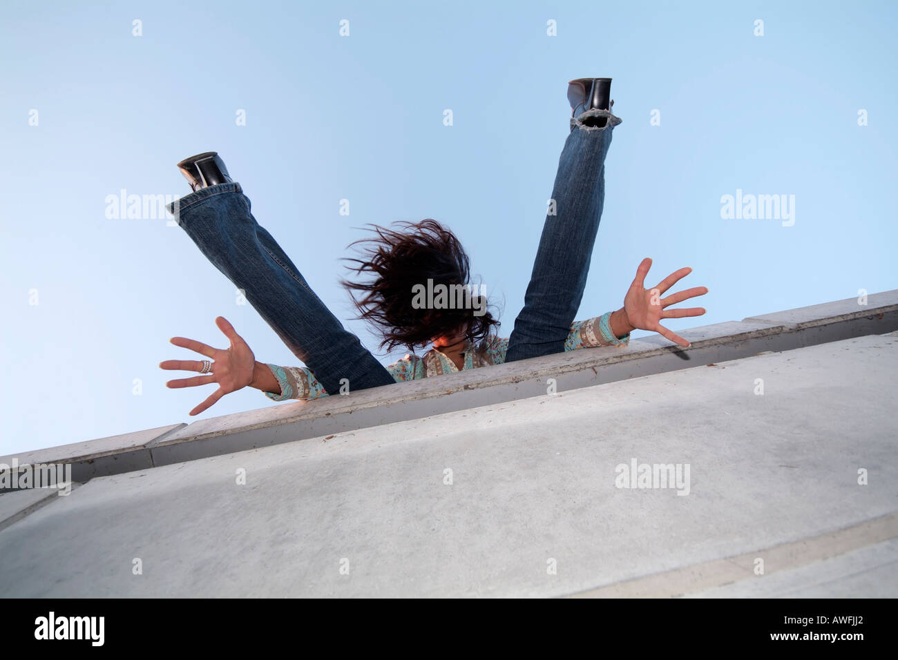 crazy girl on a wall stretching her arms and legs Stock Photo - Alamy