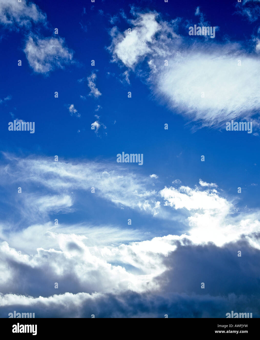 Cumulus and cirrus clouds in a blue sky Stock Photo - Alamy