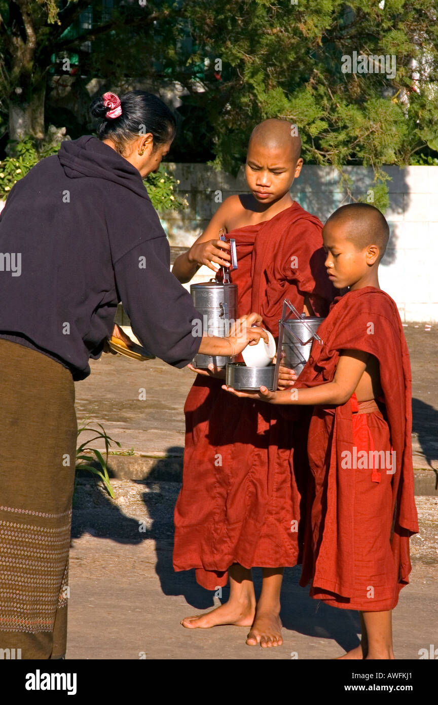 Stock photograph of young monks being given food in Kalaw in Myanmar ...