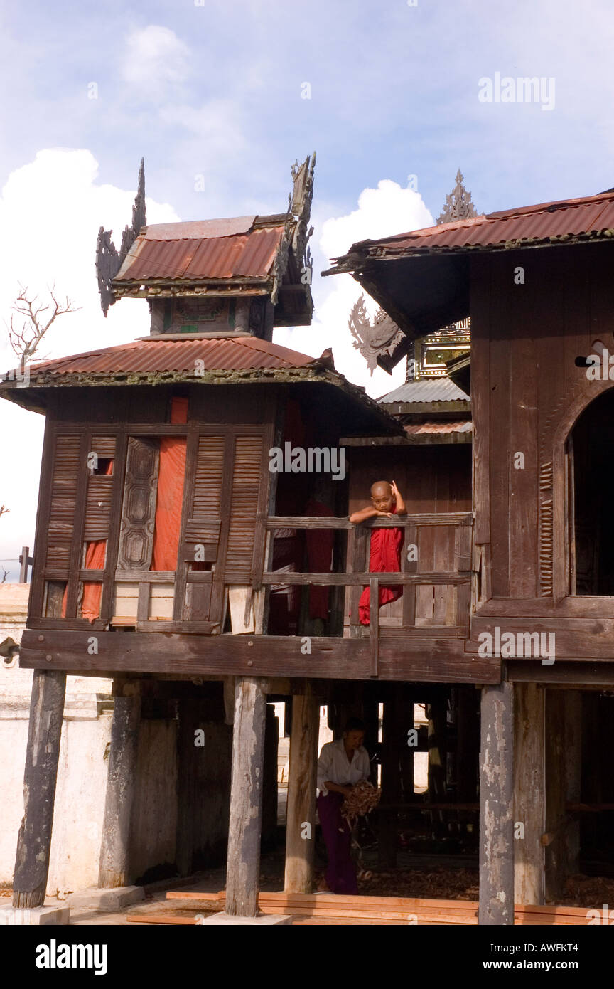 Stock photograph of a young monk in a falling down part of the Shwe ...