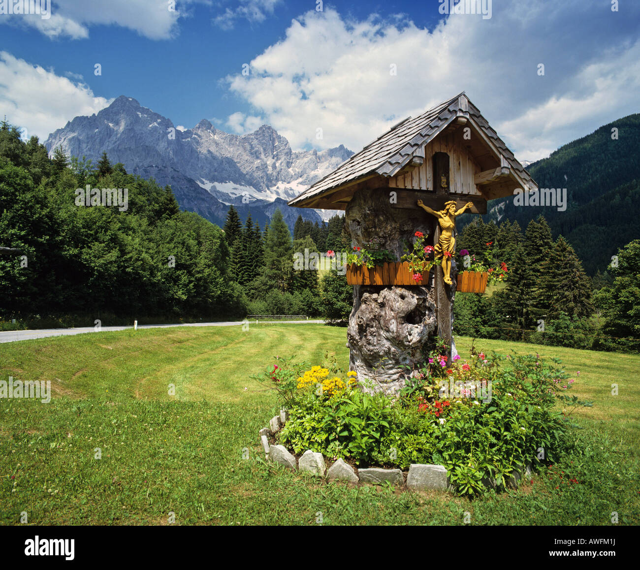 Wayside shrine with the Dachsteingebirge (Dachstein Range) in the ...