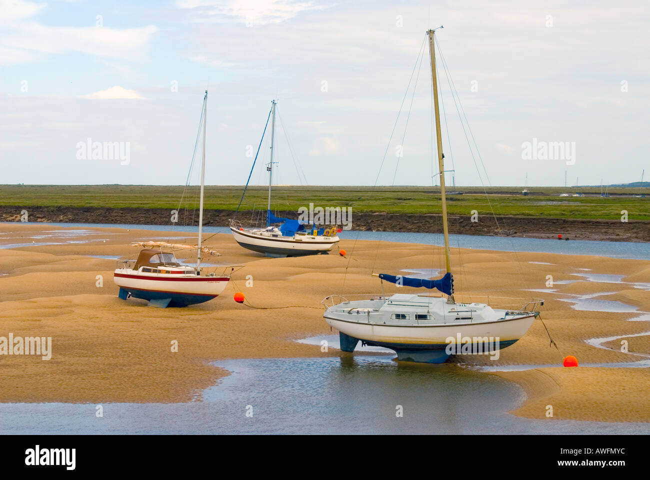 Three boats marooned on sand in Wells Next To Sea in Norfolk on England ...