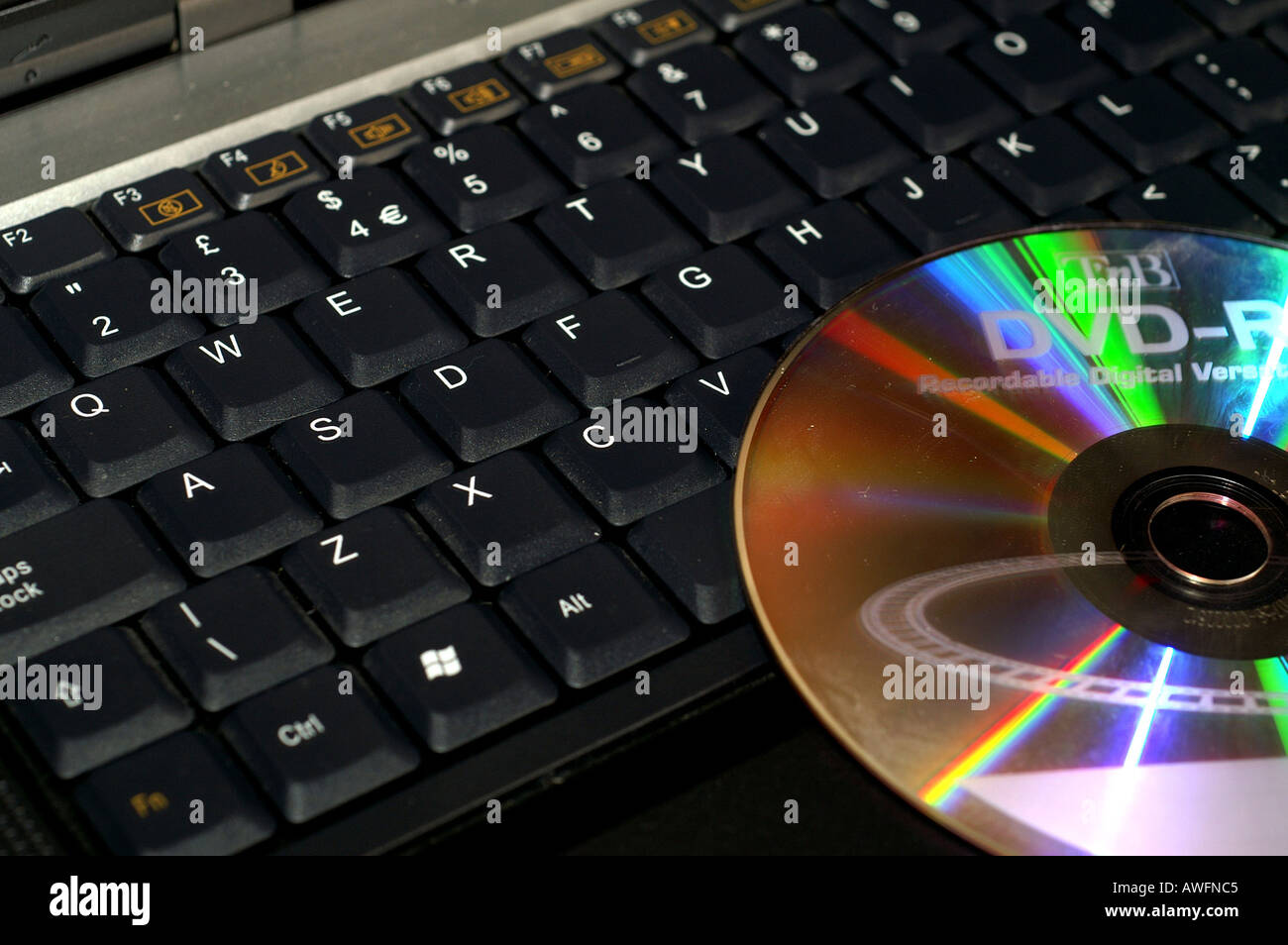 DVD on laptop keyboard light diffraction spectrum colours Stock Photo ...