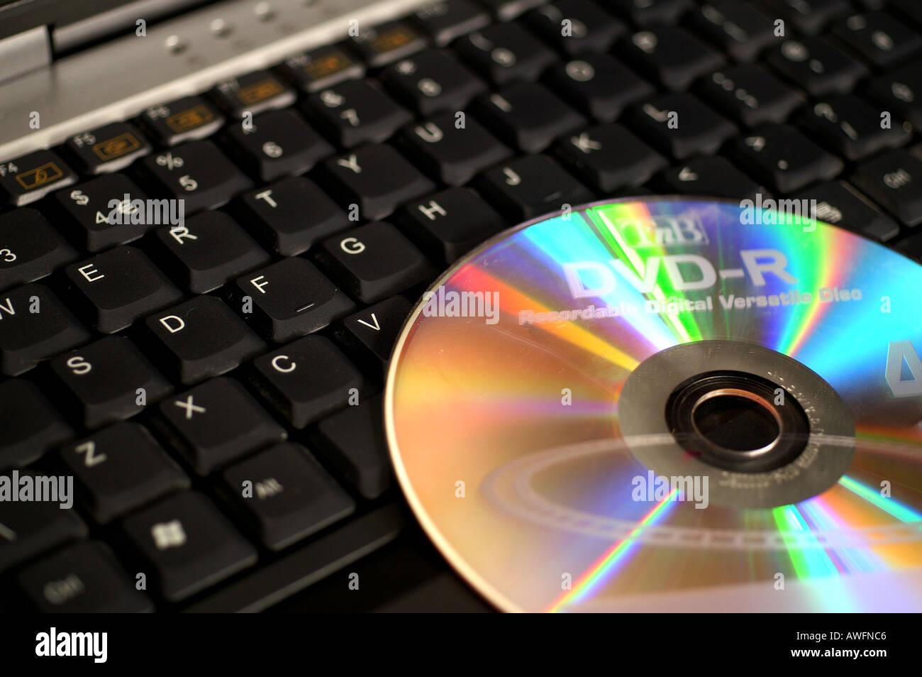 DVD on laptop keyboard light diffraction spectrum colours Stock Photo ...