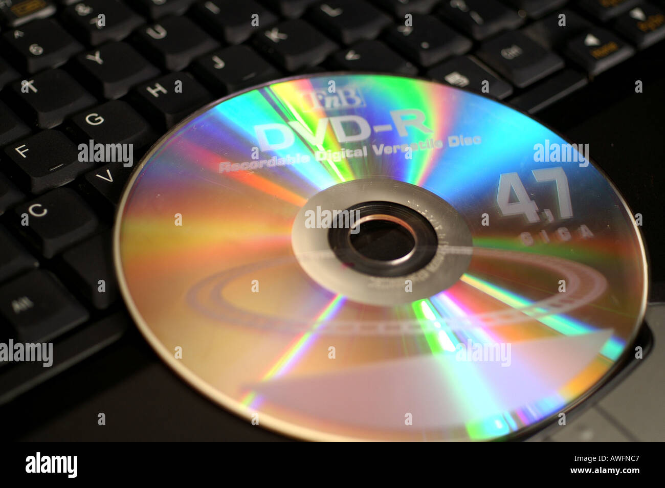 DVD on laptop keyboard light diffraction spectrum colours Stock Photo ...