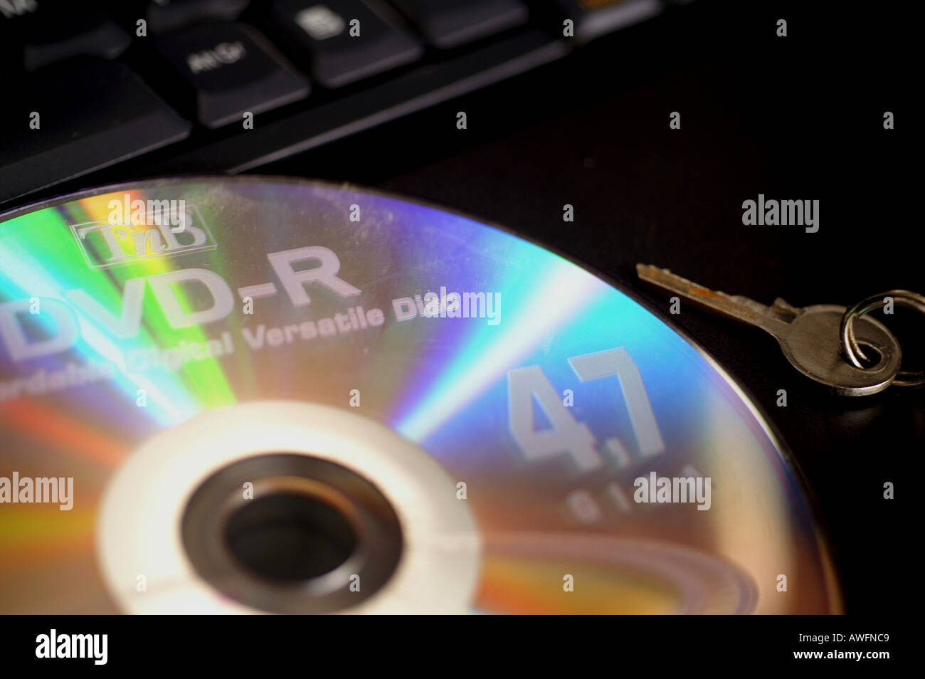 DVD on laptop keyboard with key showing light diffraction spectrum ...