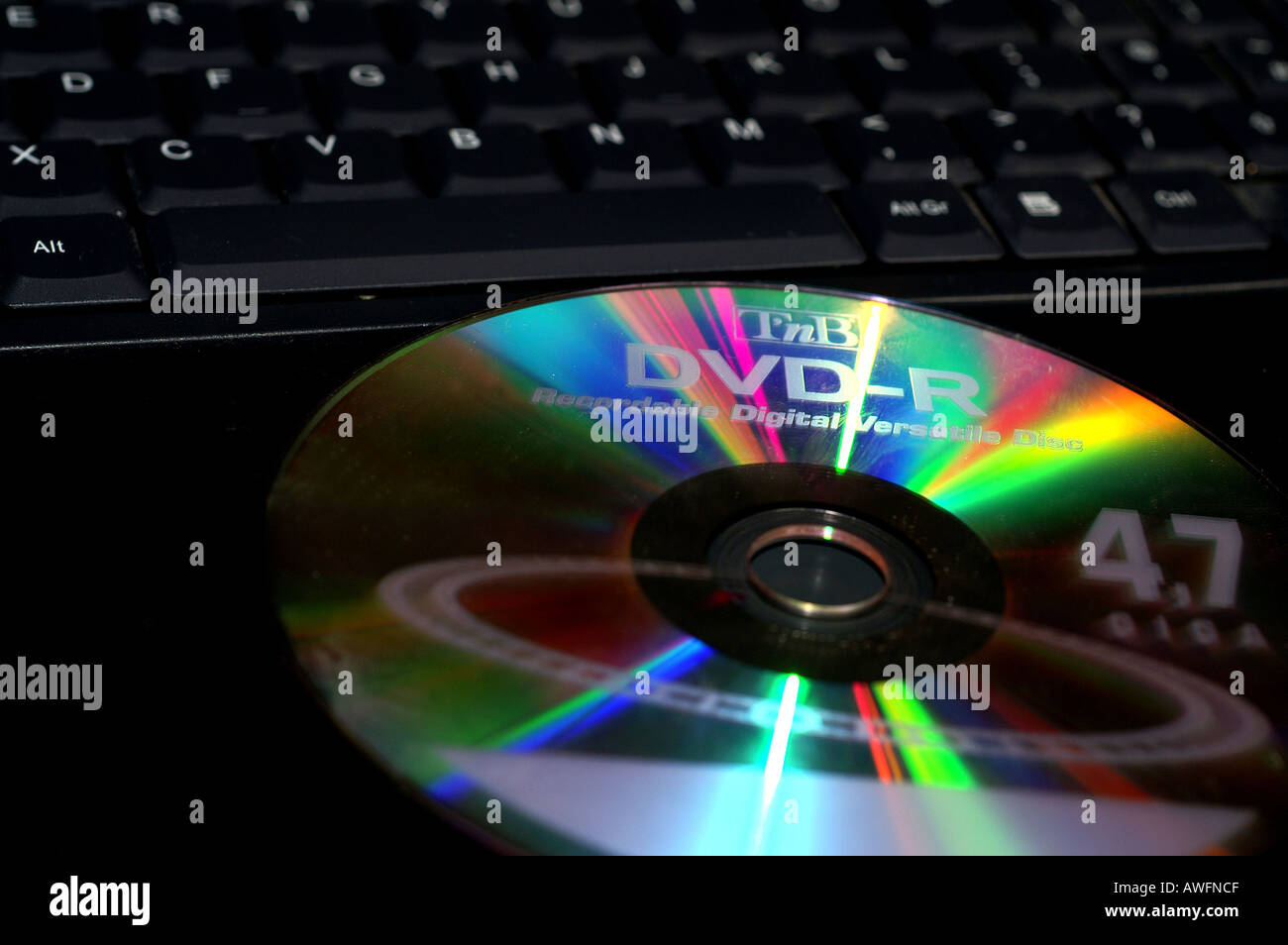 DVD on laptop keyboard light diffraction spectrum colours Stock Photo ...