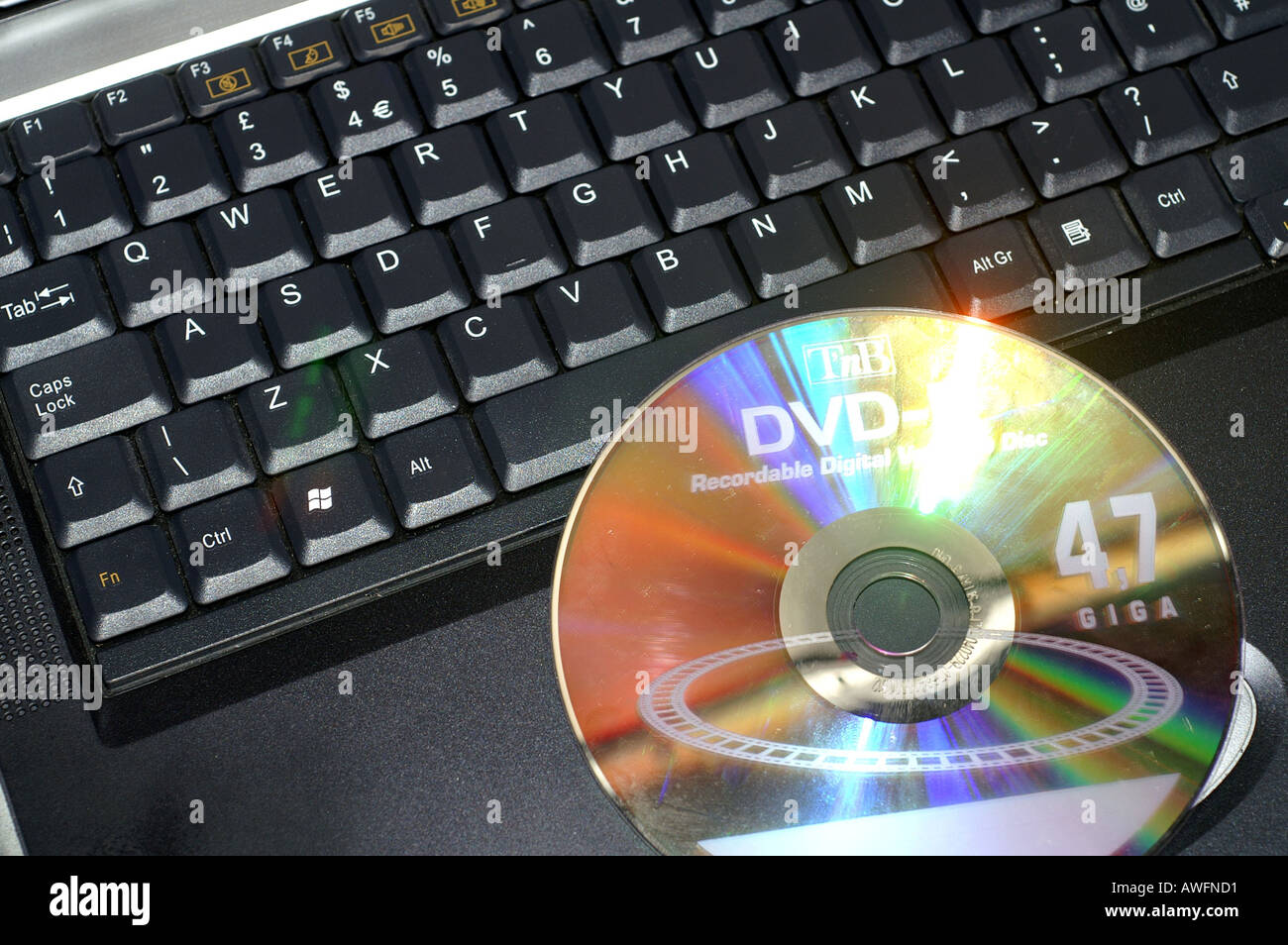 DVD on laptop keyboard light diffraction spectrum colours Stock Photo ...