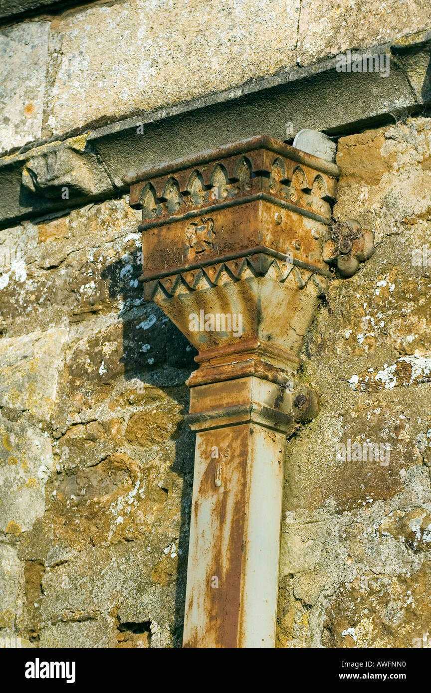 Old lead gutter drainpipe on the side of a church showing intricate ...