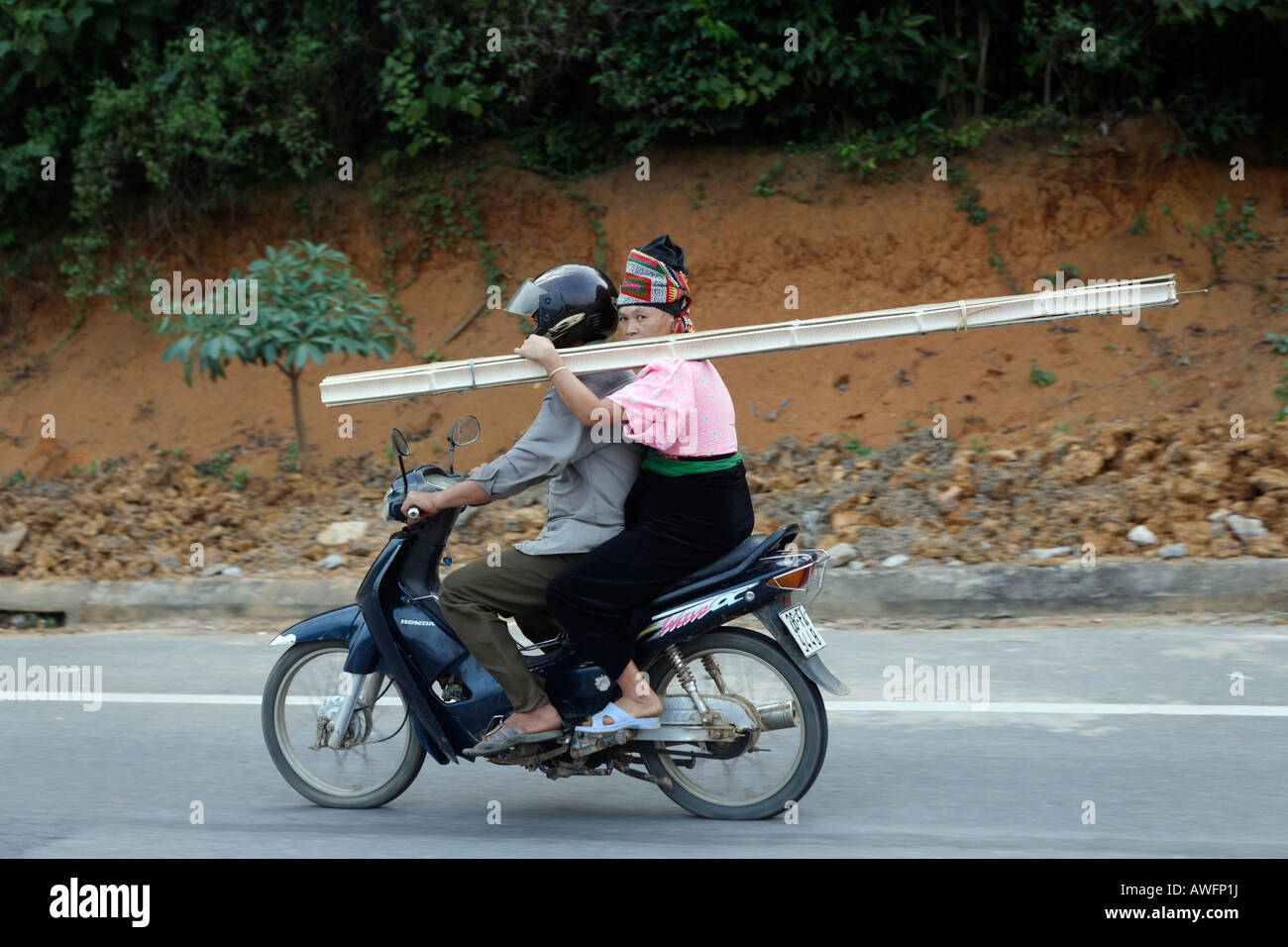 Moped riders transporting curtain rail, Son La Province, Vietnam, Asia ...