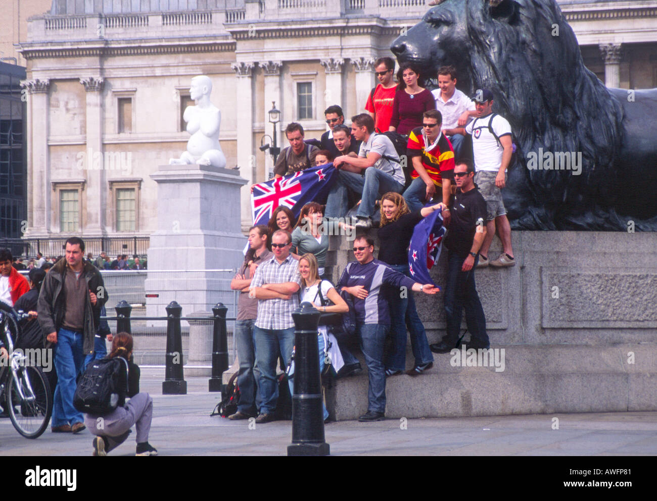 Tourist group pose for camera Trafalgar Square London England Stock Photo - Alamy