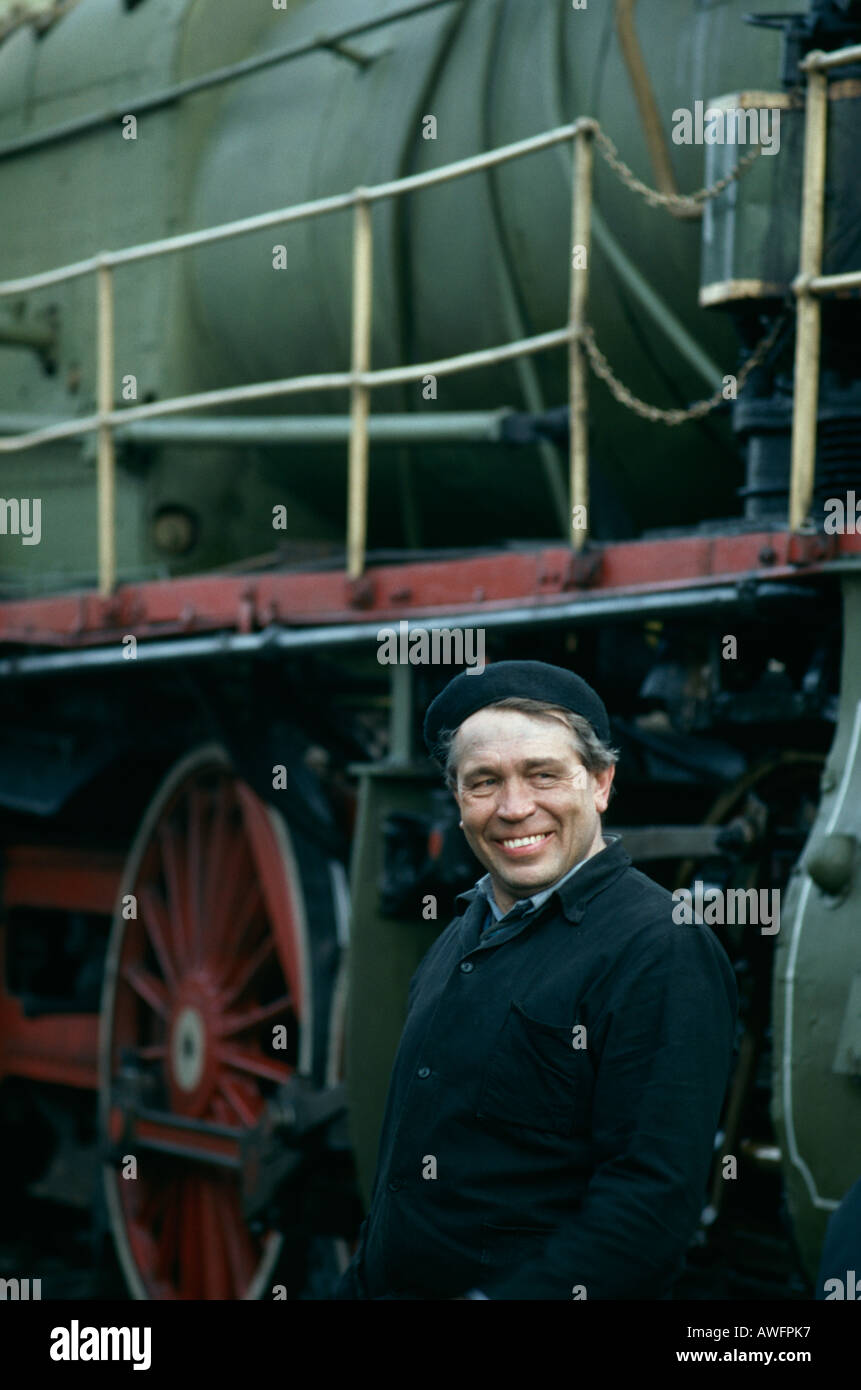 Sasha, a russian train driver standing next to a Type SU steam ...