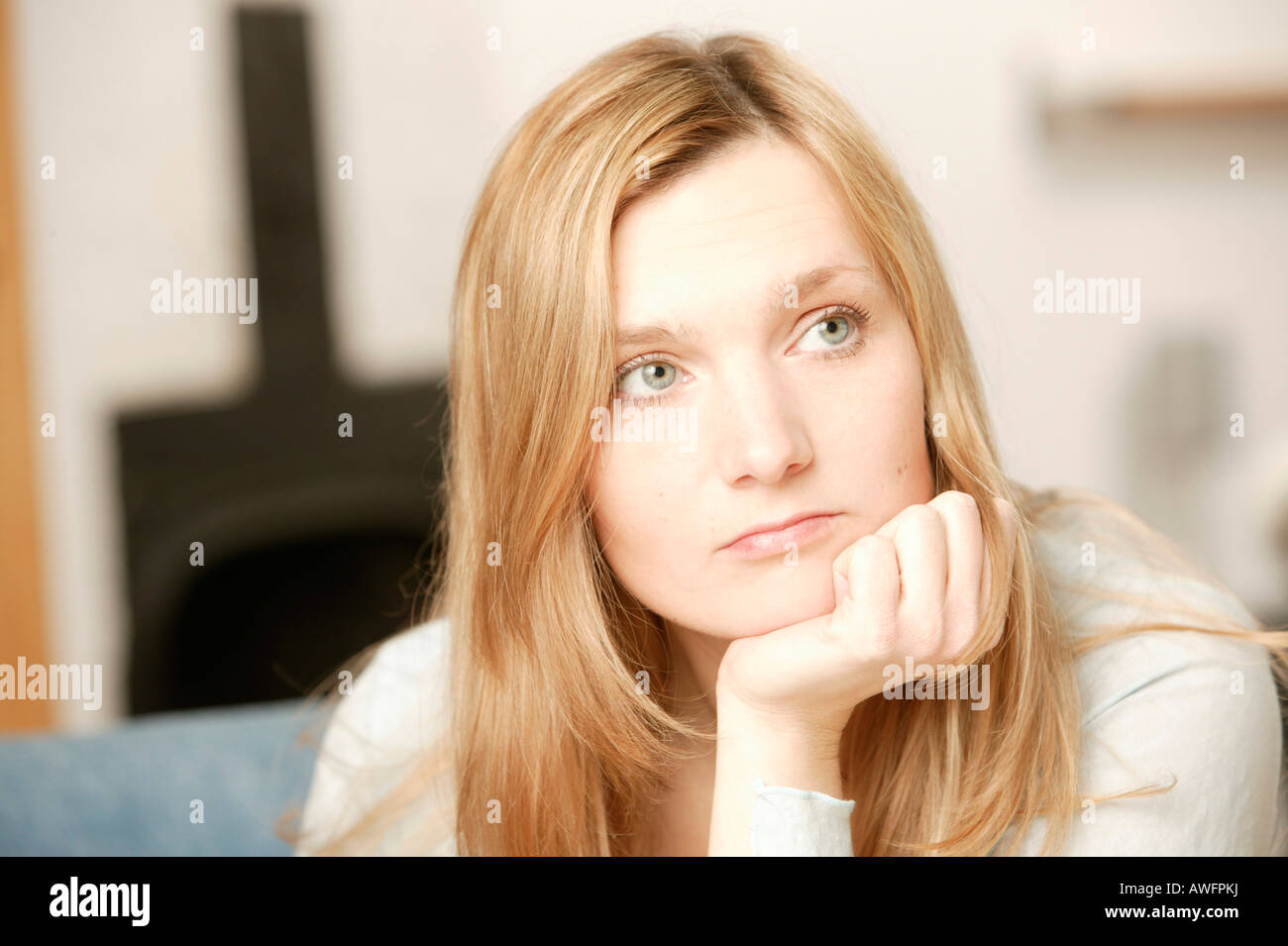 Young blonde woman pondering Stock Photo - Alamy