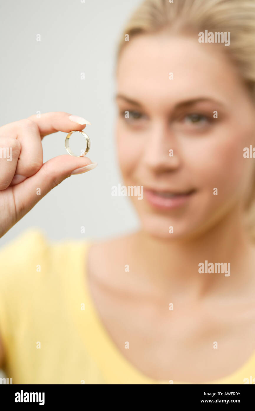 Young blonde woman looks at a wedding ring Stock Photo - Alamy