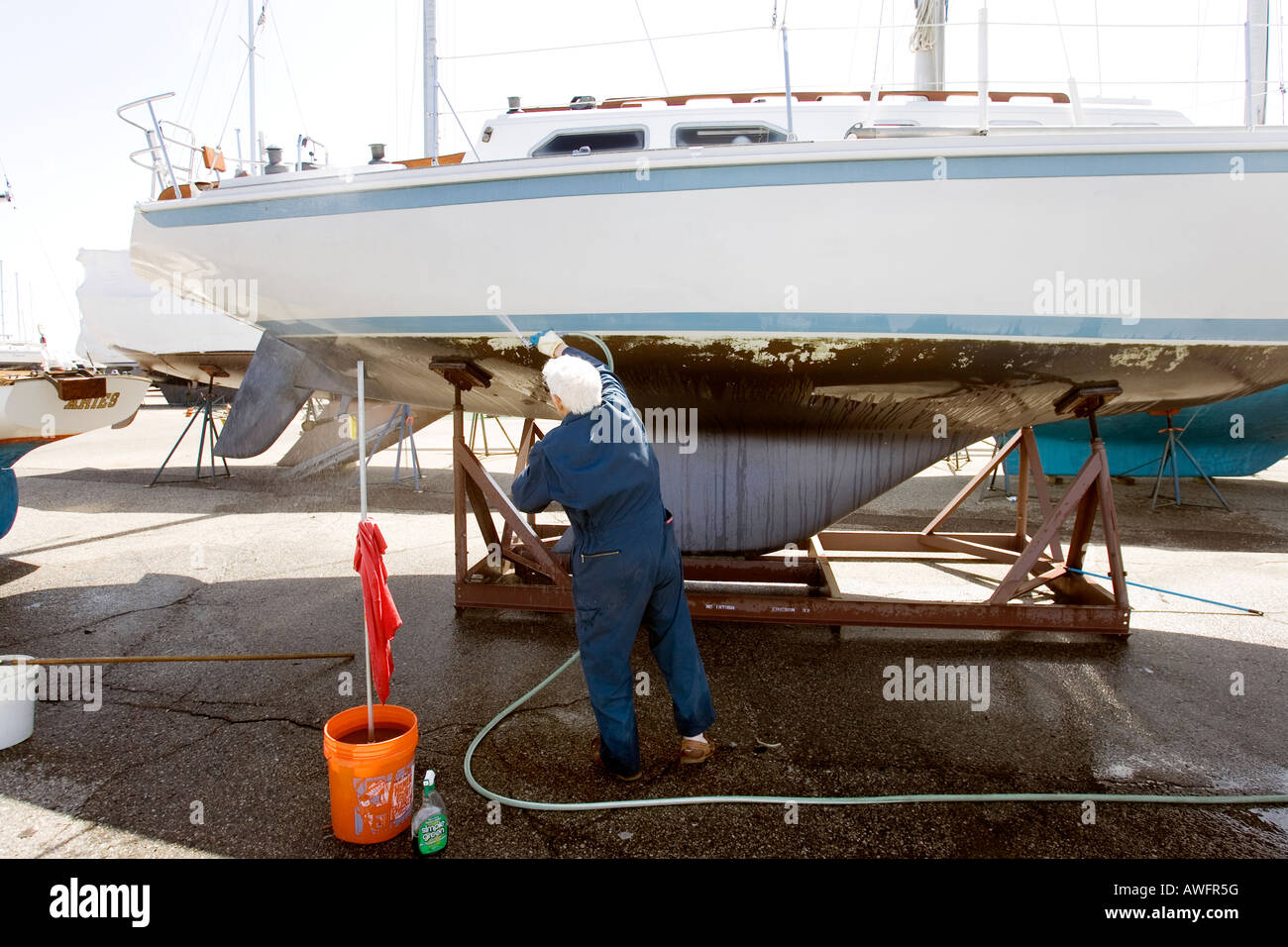 Man washing his sailboat in docking area of marina St Clair Shores ...