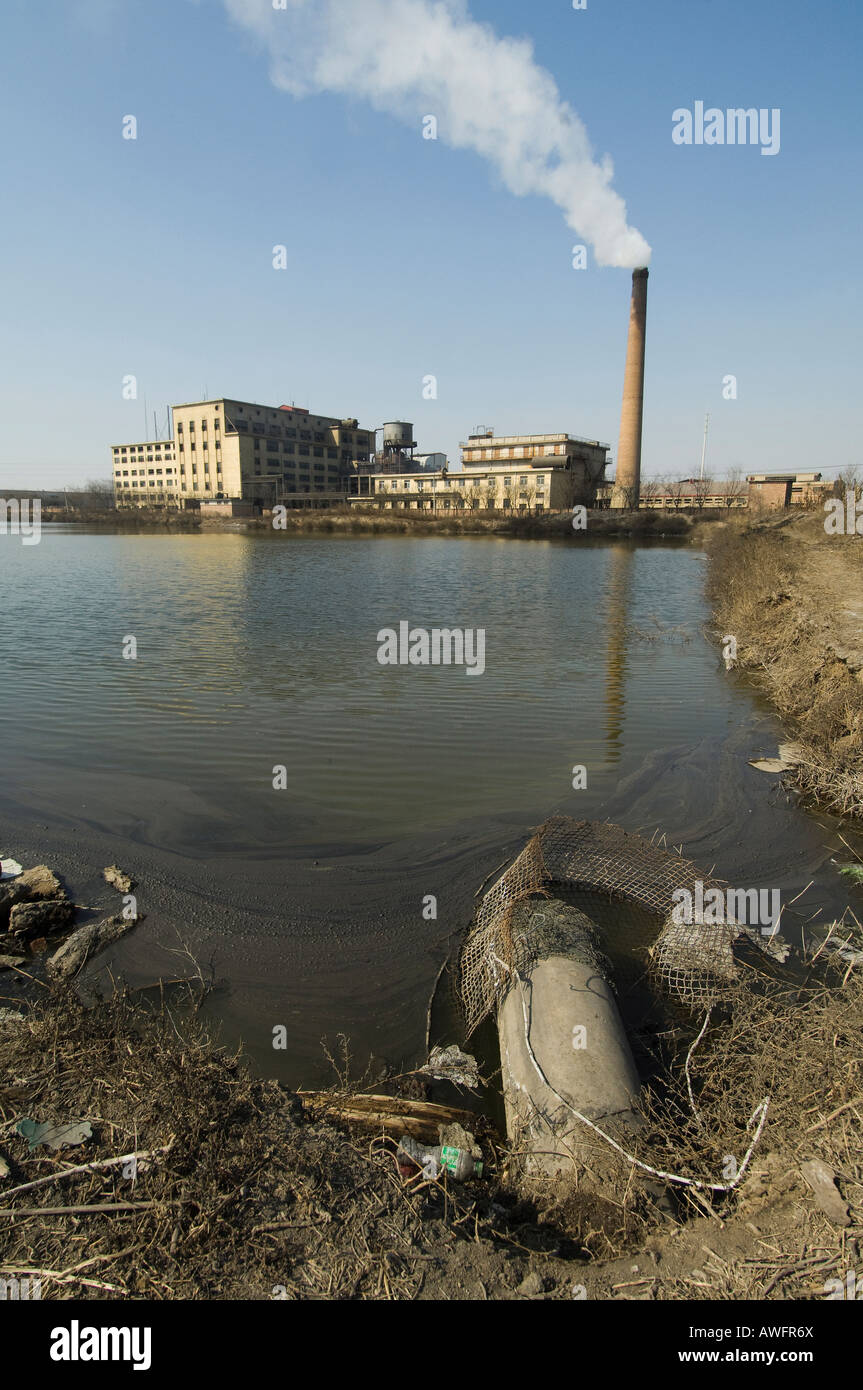 Pollution and smoke belch from the chimney of a factory to the east of ...