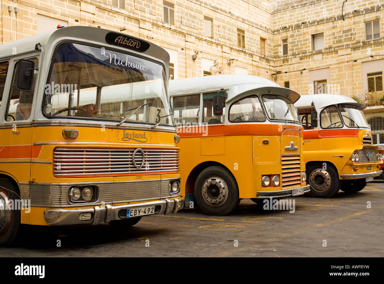 old british yellow buses in malta Stock Photo - Alamy