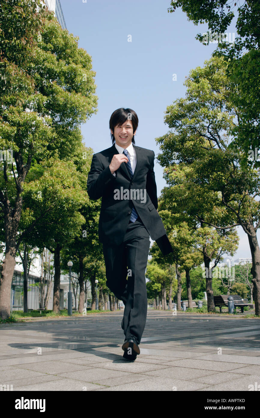 A young man in suit running Stock Photo - Alamy