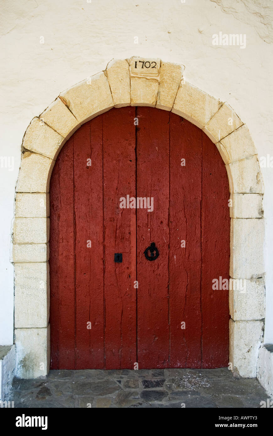 large old red wooden door in small chapel adjacent to the cemetery of ...