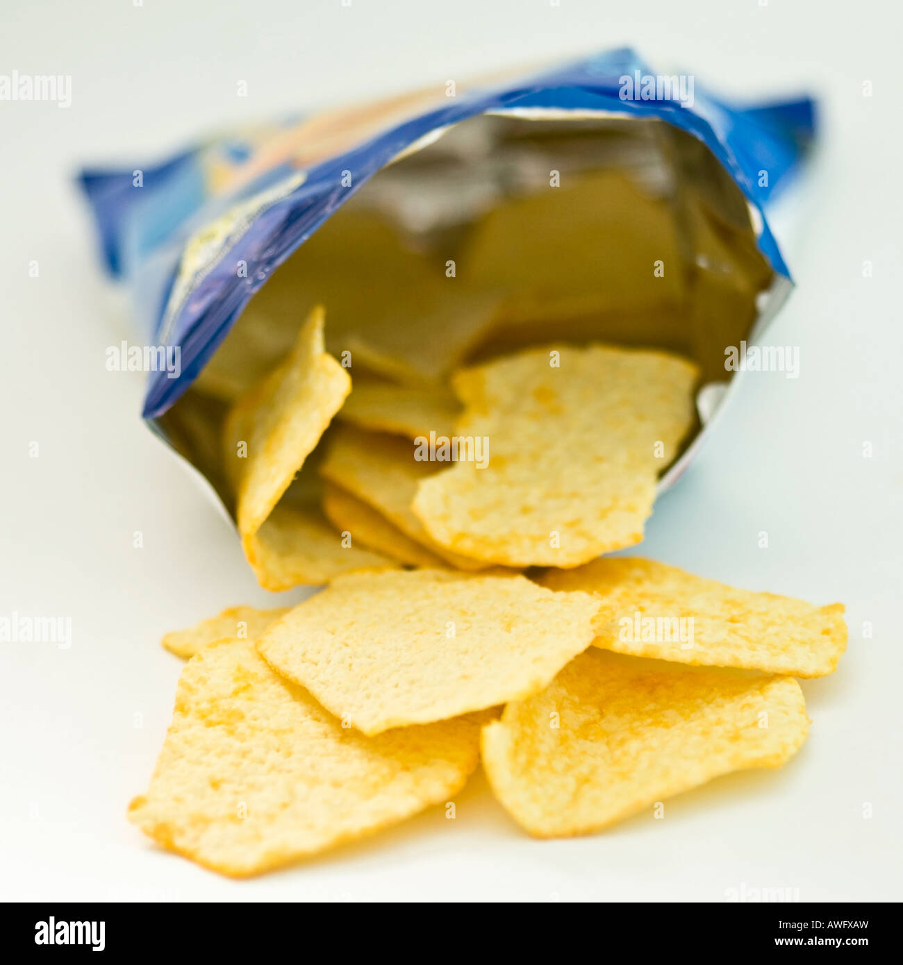 Open bag of potato crisps on white background Stock Photo - Alamy