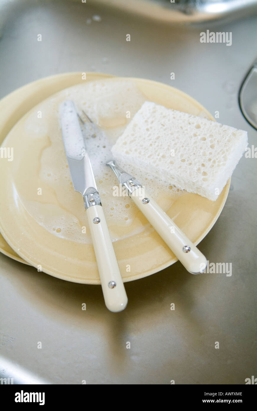 Washed dishes in kitchen sink Stock Photo - Alamy