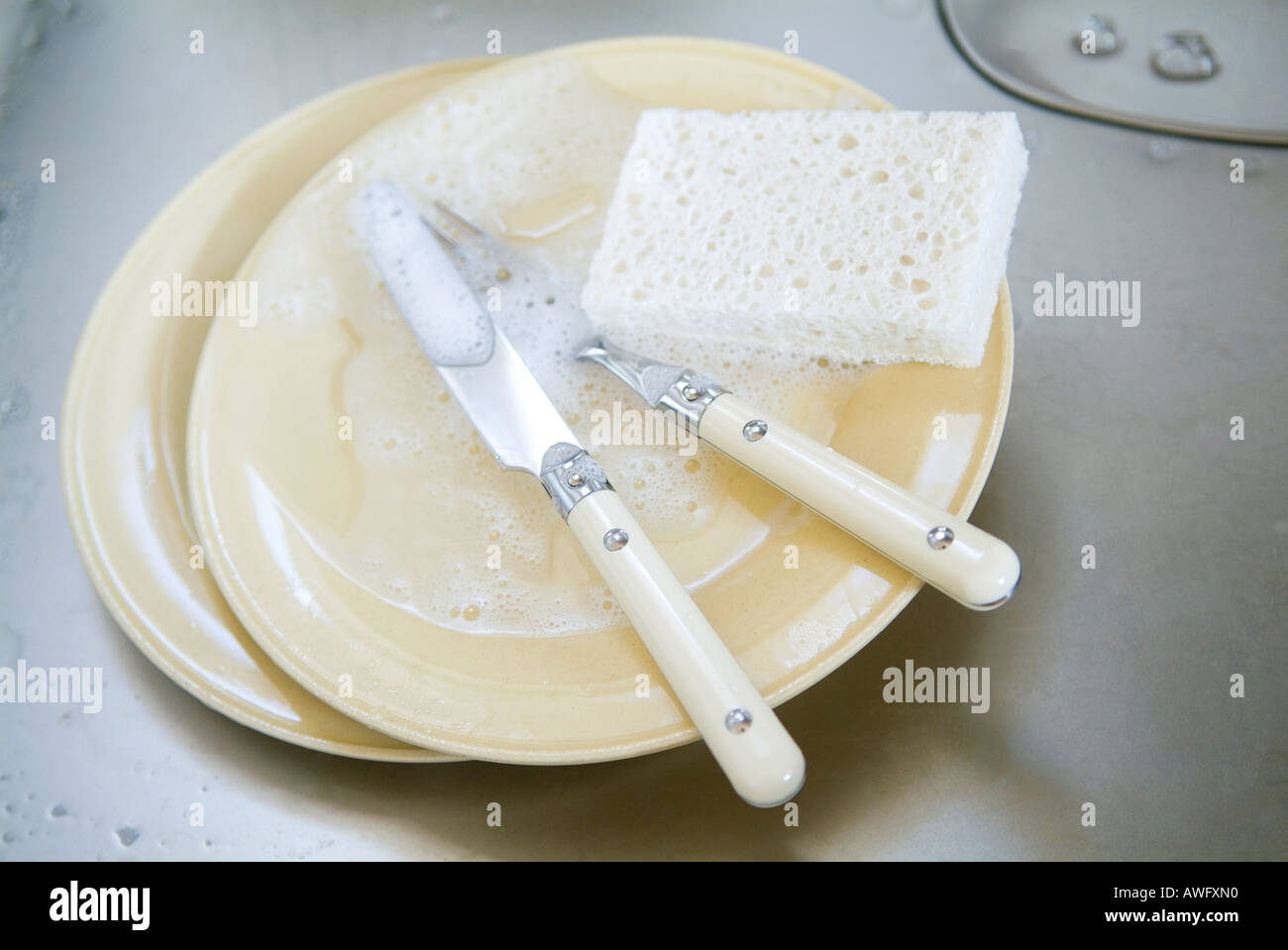 Washed dishes in kitchen sink Stock Photo - Alamy