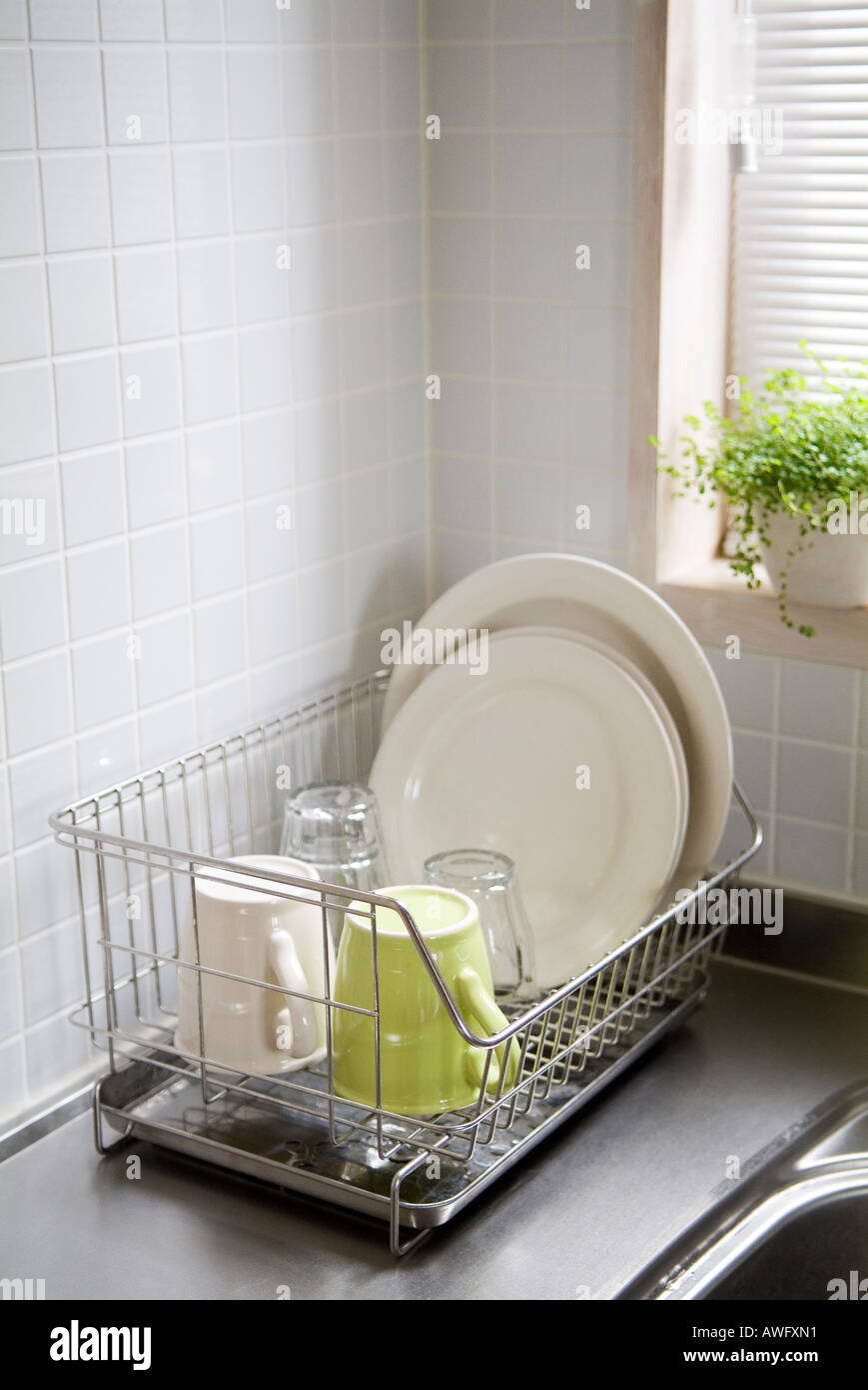 Washed dishes in dish rack Stock Photo - Alamy