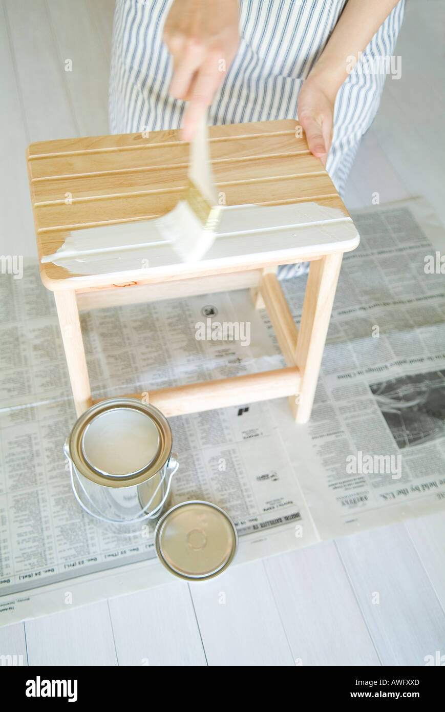 A woman painting a stool Stock Photo - Alamy