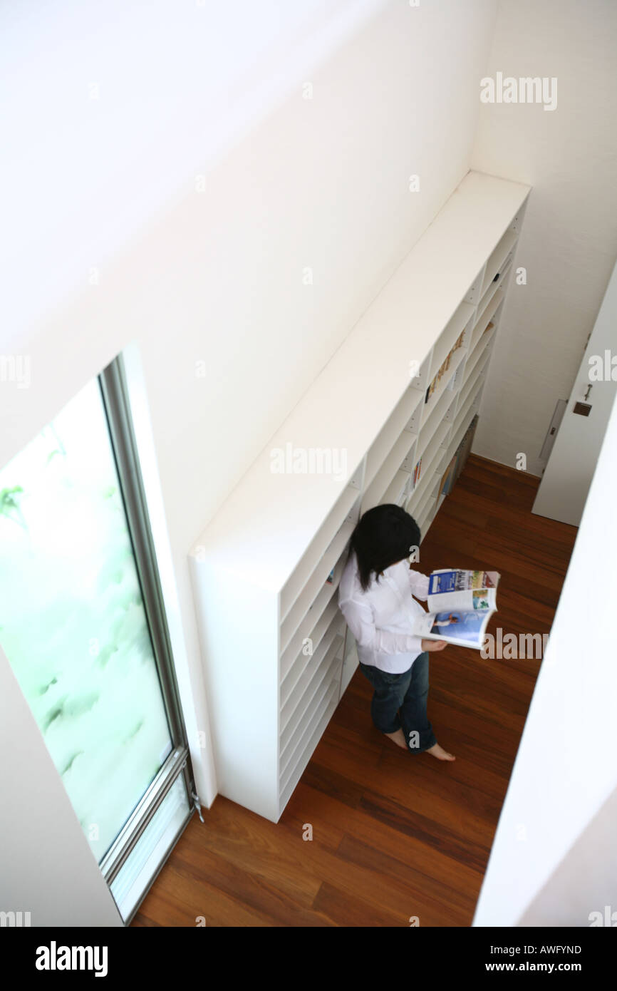 Reading a magazine standing hi-res stock photography and images - Alamy