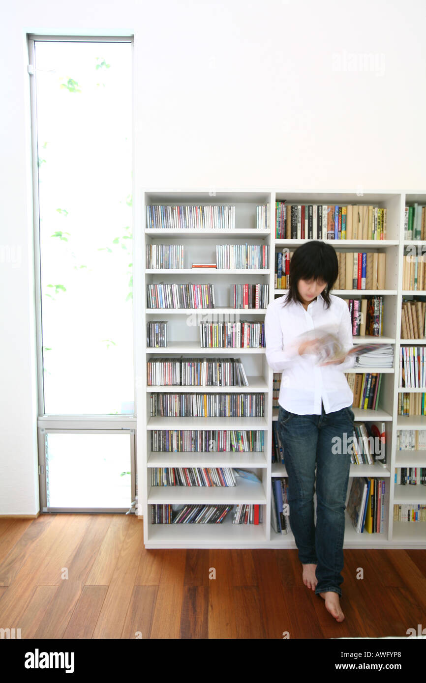 Reading a magazine standing hi-res stock photography and images - Alamy