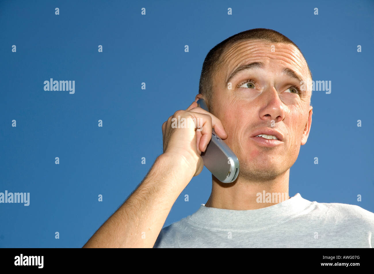 Boy on the phone looking surprised Stock Photo - Alamy