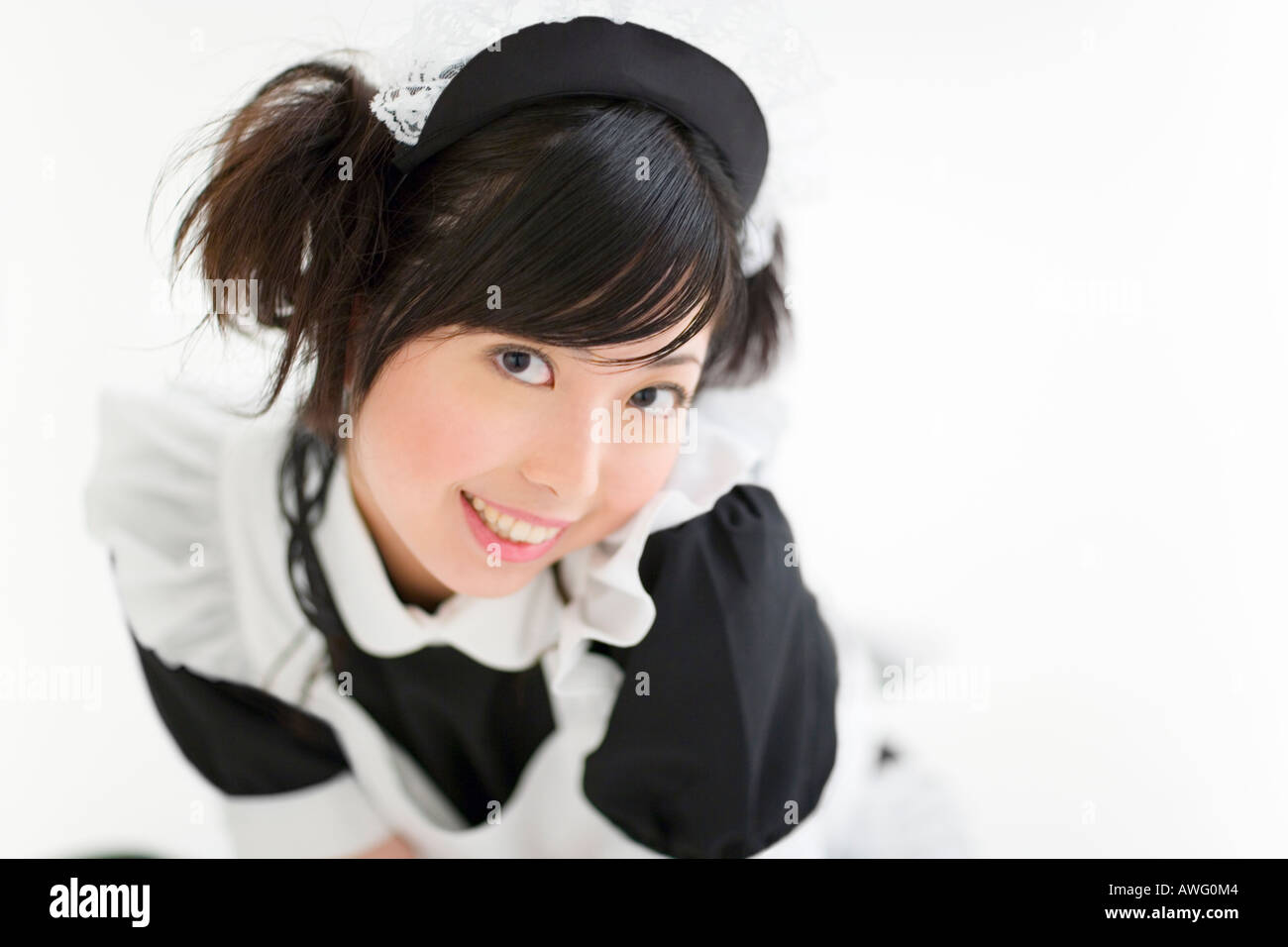 A young woman in French maid outfit smiling Stock Photo - Alamy
