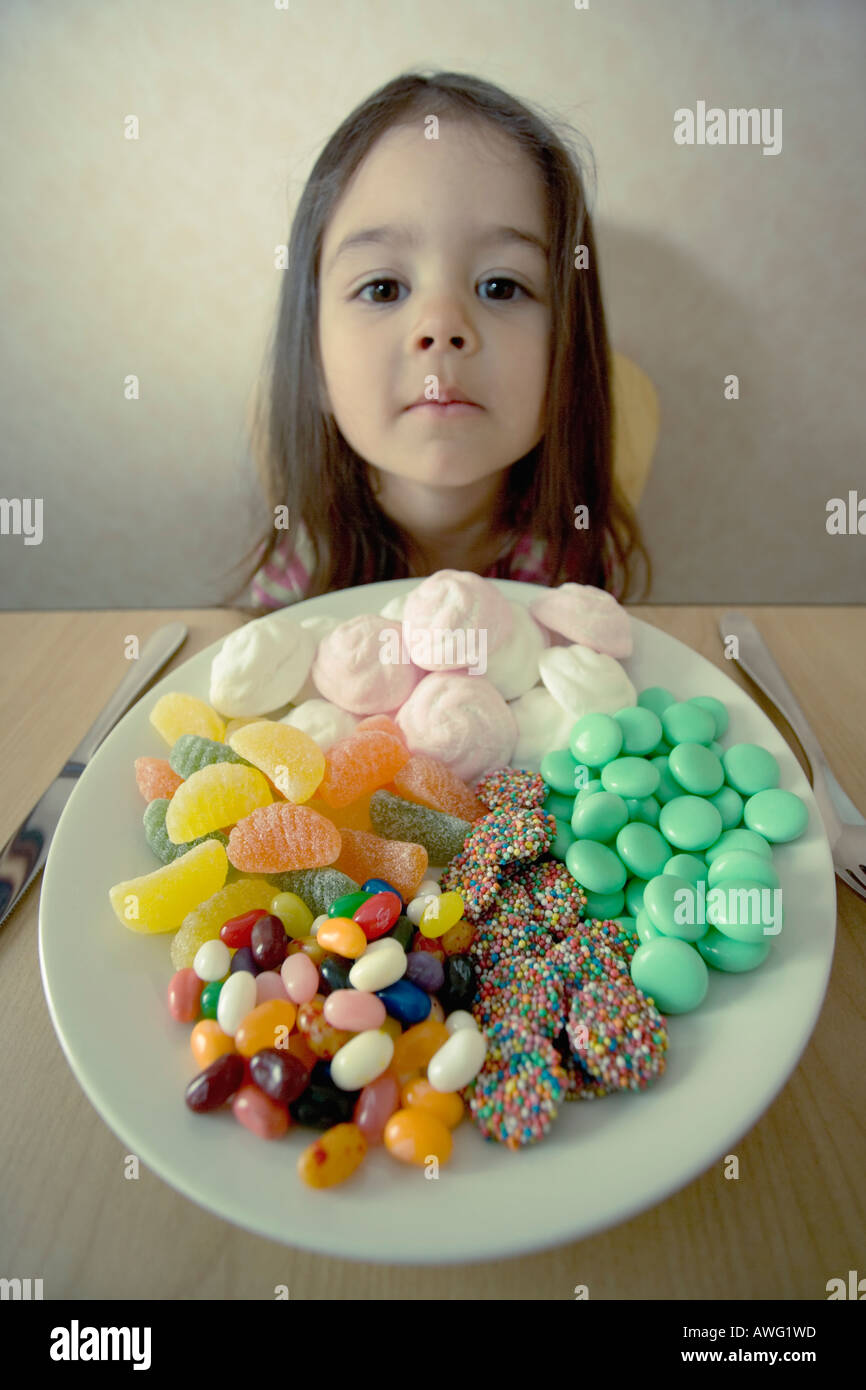 Obese child eating sweets hi-res stock photography and images - Alamy